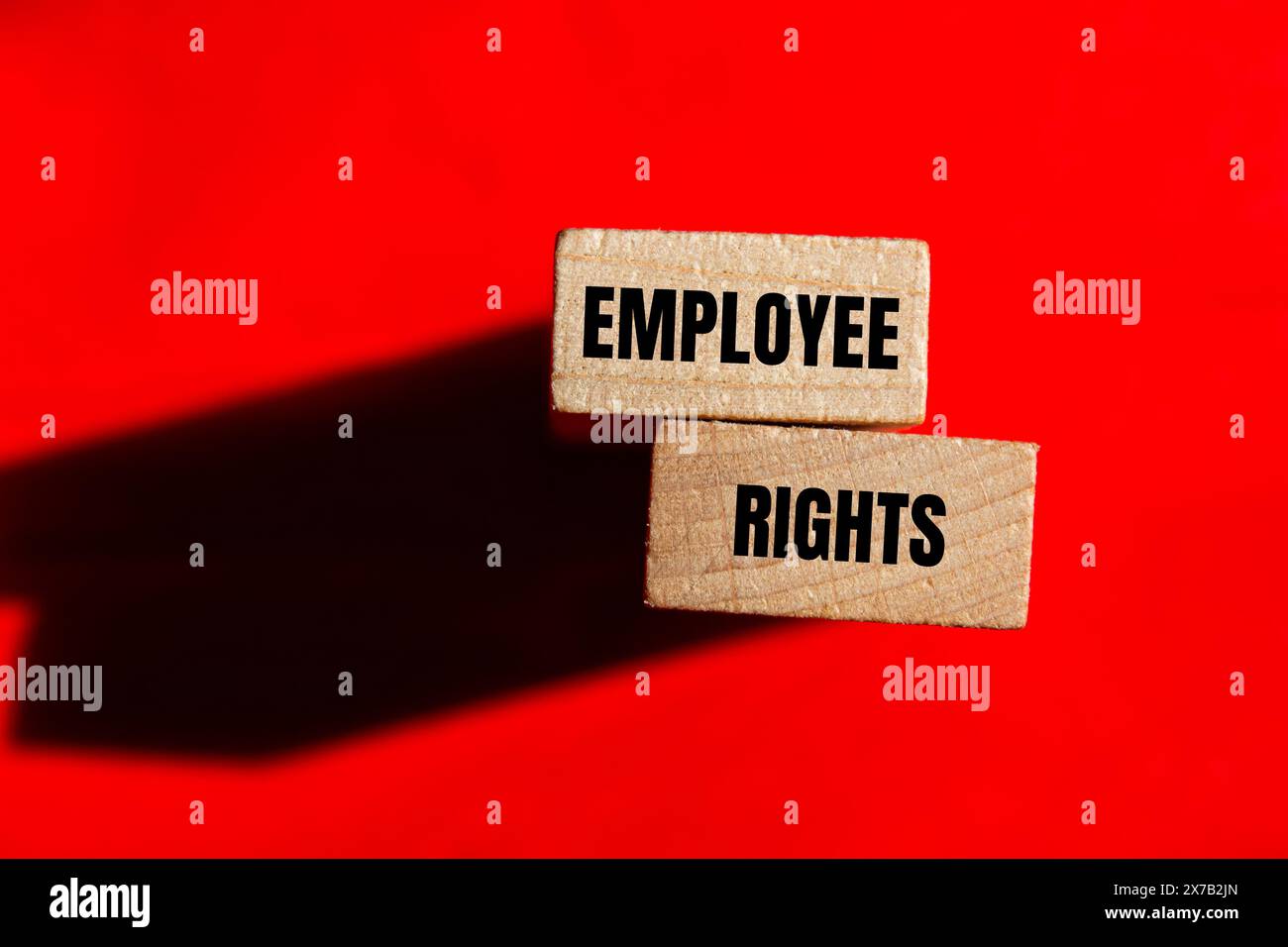 Employee rights words written on wooden blocks with red background ...