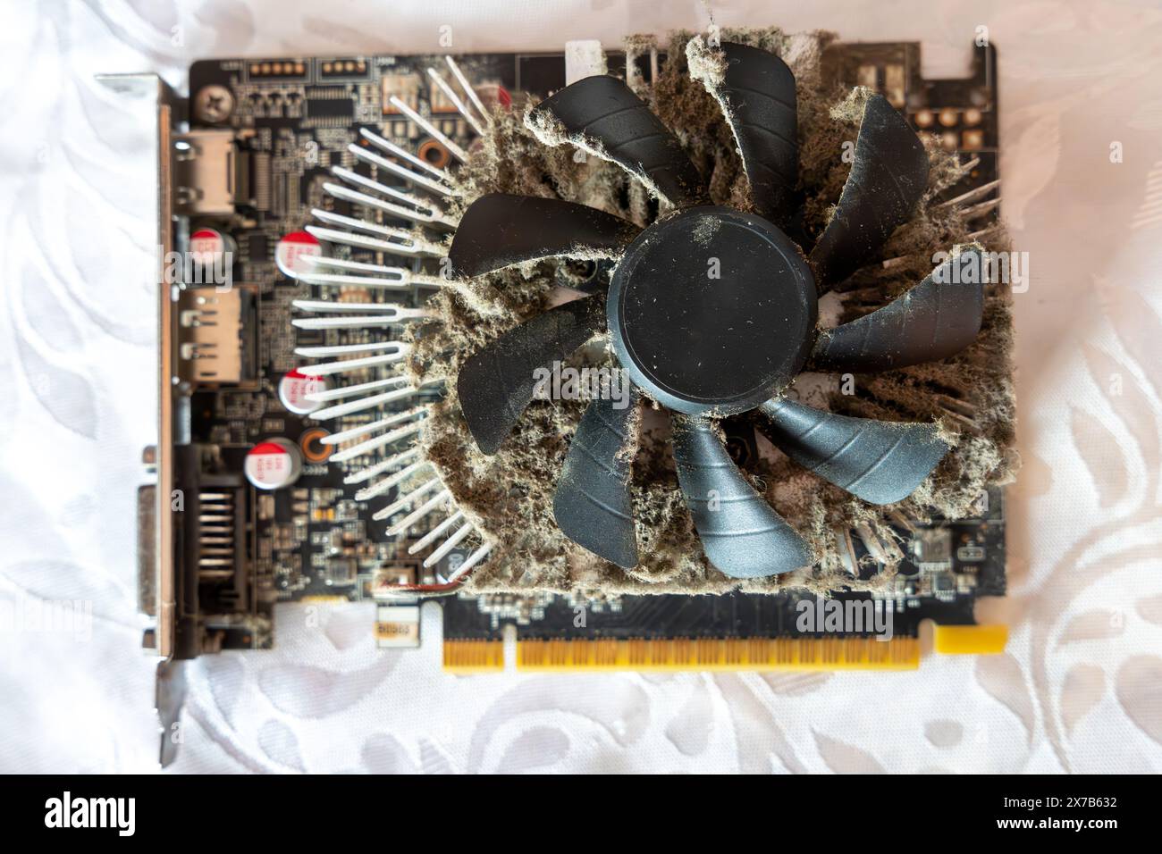 Small video card with very dusty cooler fan Stock Photo - Alamy