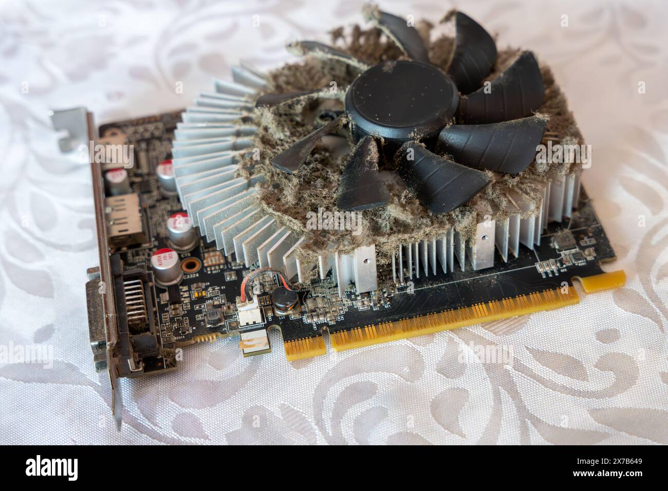Small video card with very dusty cooler fan Stock Photo - Alamy
