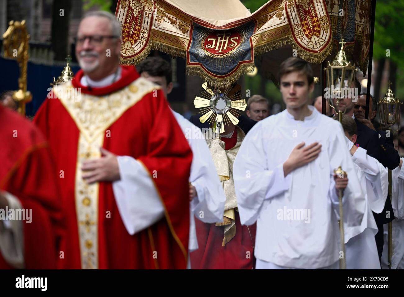 The Eucharistic host is held in a monstrance during a procession ...