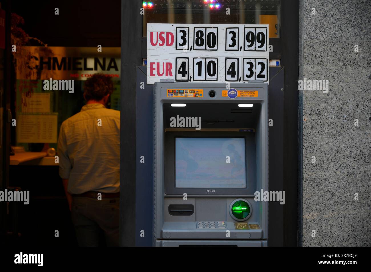 A man is seen inside a shop with a cash withdrawal ATM machine with ...
