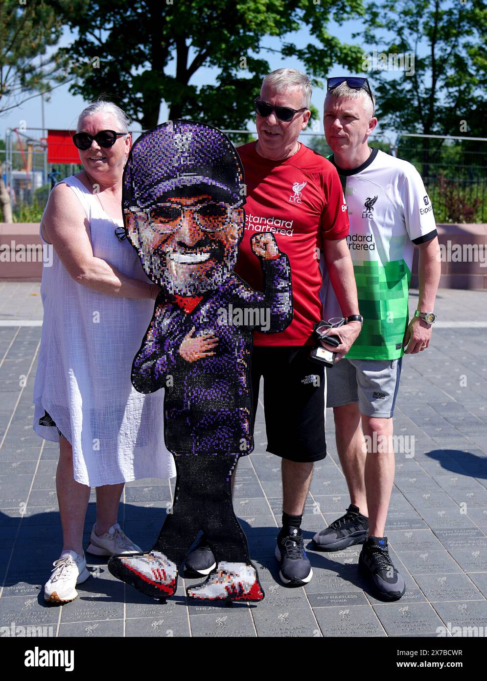 Liverpool fans pose for a photo with a design of Jurgen Klopp made out ...