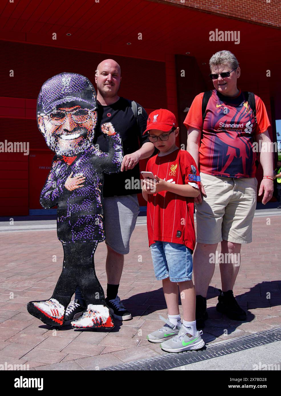 Liverpool fans pose for a photo with a design of Jurgen Klopp made out ...