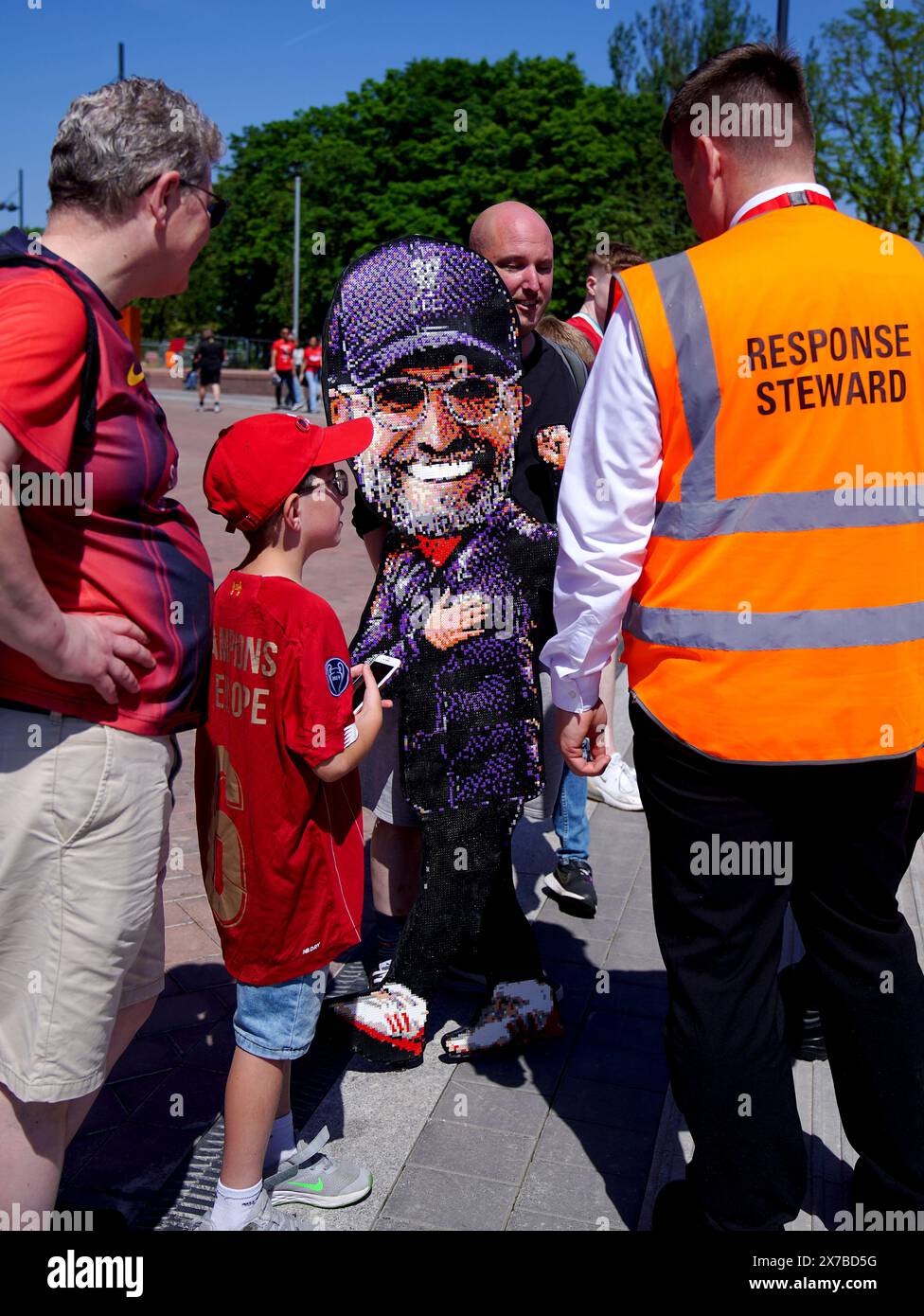 A steward fans looks at a design of Liverpool manager Jurgen Klopp made ...