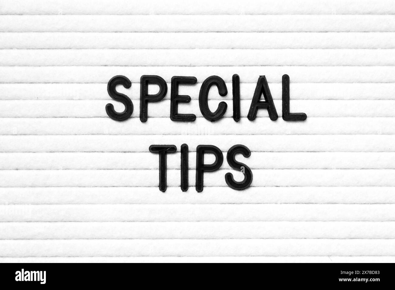 Black color letter in word special tips on white felt board background ...