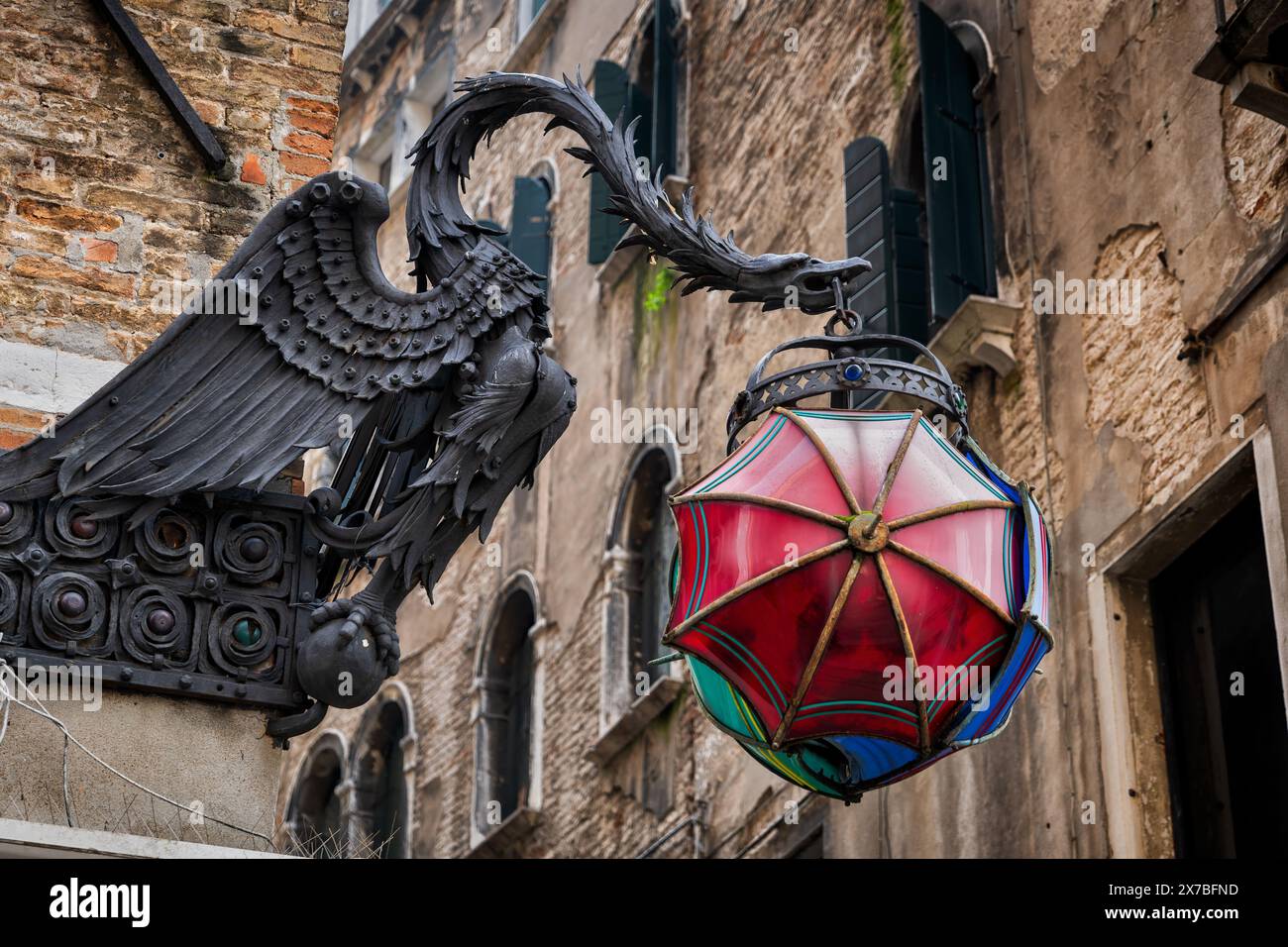 The Marforio Dragon with the umbrellas in city of Venice, Italy. Corner ...