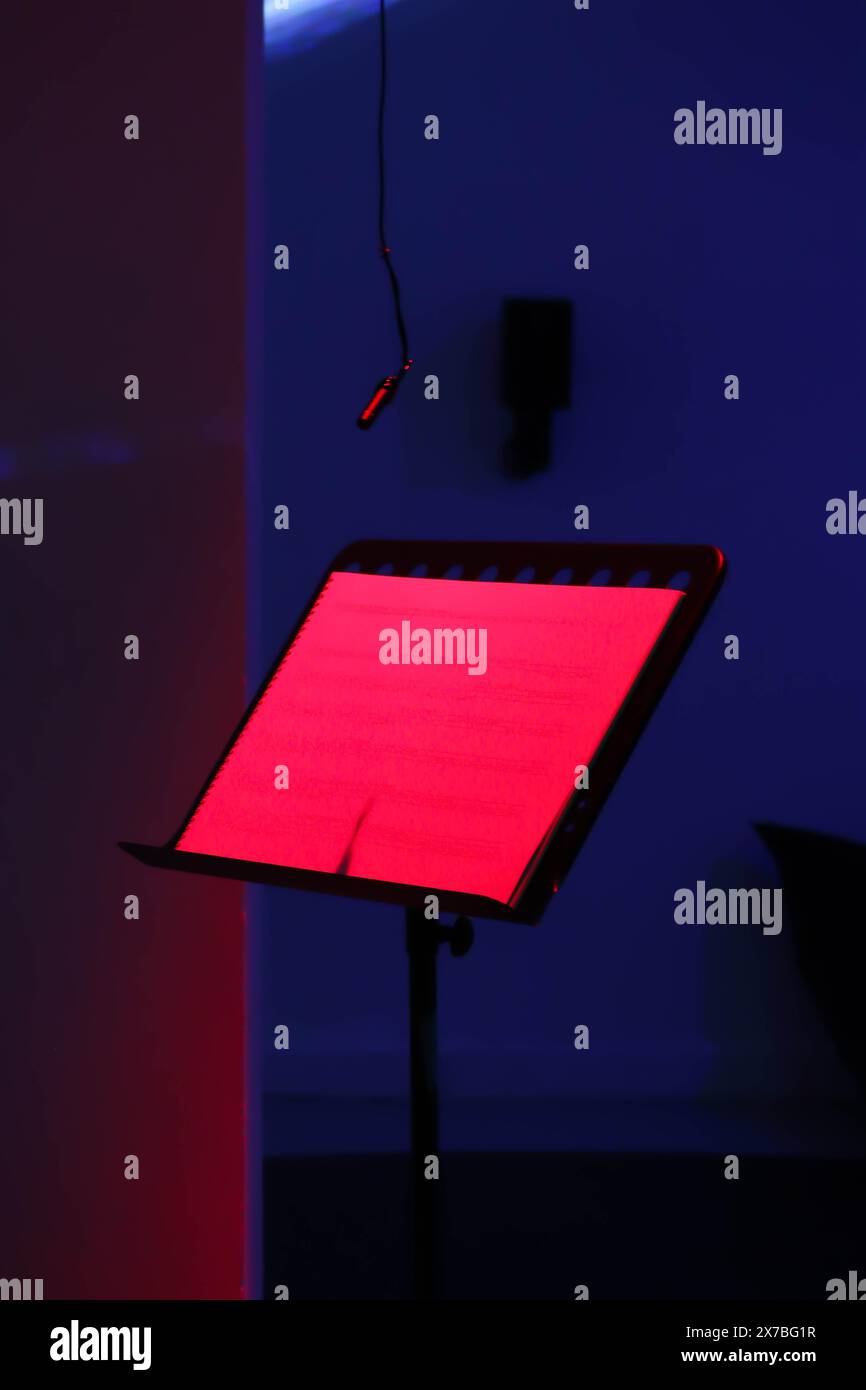 Music stand with text and microphone, recording studio Stock Photo - Alamy