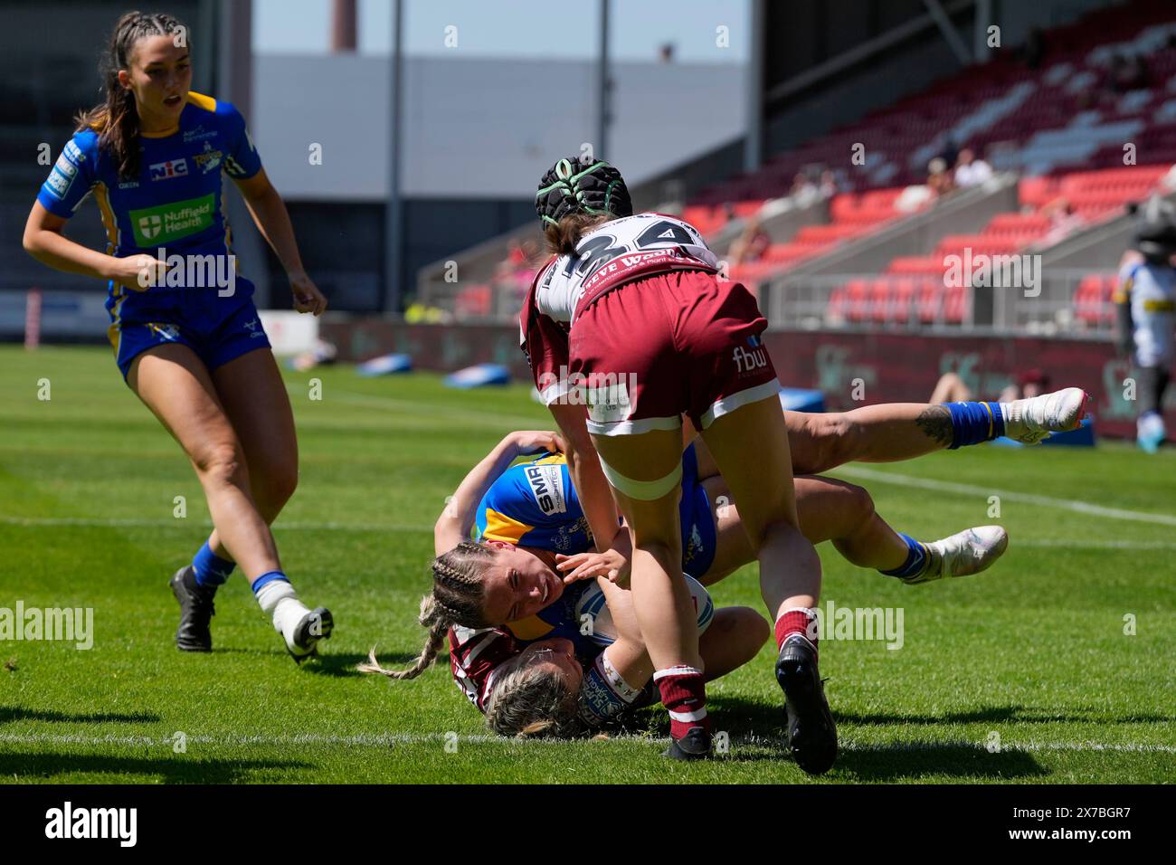 Caitlin Beevers of Leeds Rhinos drives into the Wigan Warriors defence ...
