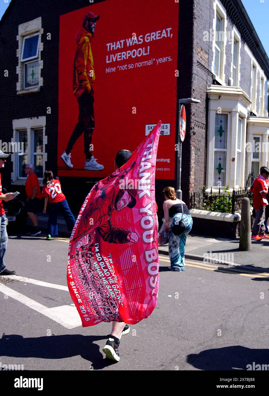 A Liverpool fan carries a banner for manager Jurgen Klopp ahead of the ...