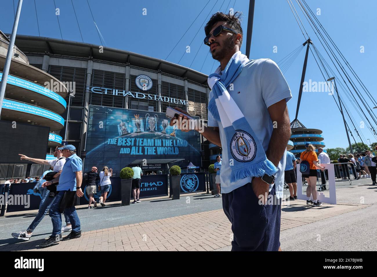 Man City fans arrive at the Etihad Stadium with the sun shining and ...