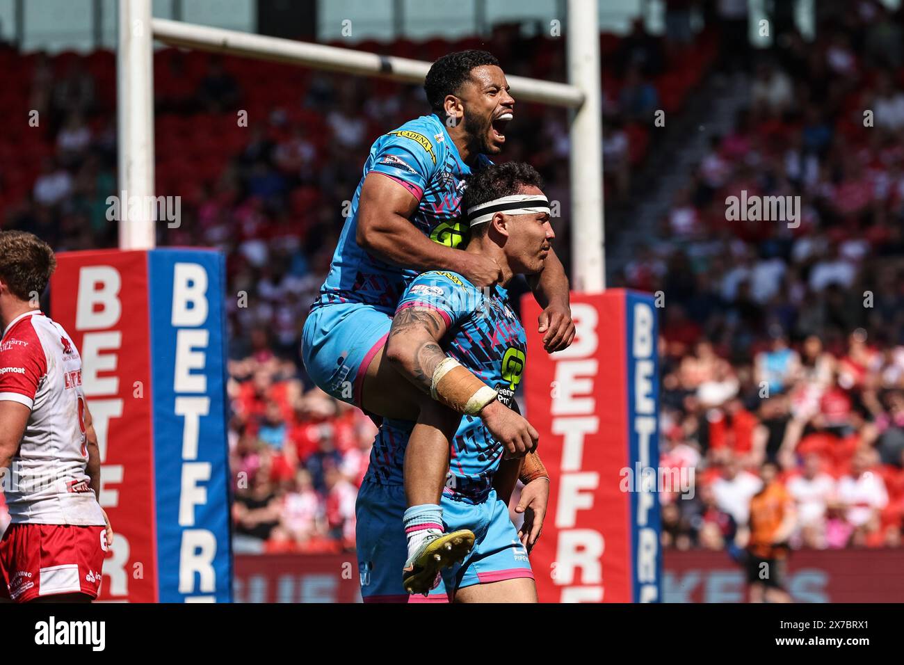 Tyler Dupree of Wigan Warriors celebrates their try with Kruise Leeming ...