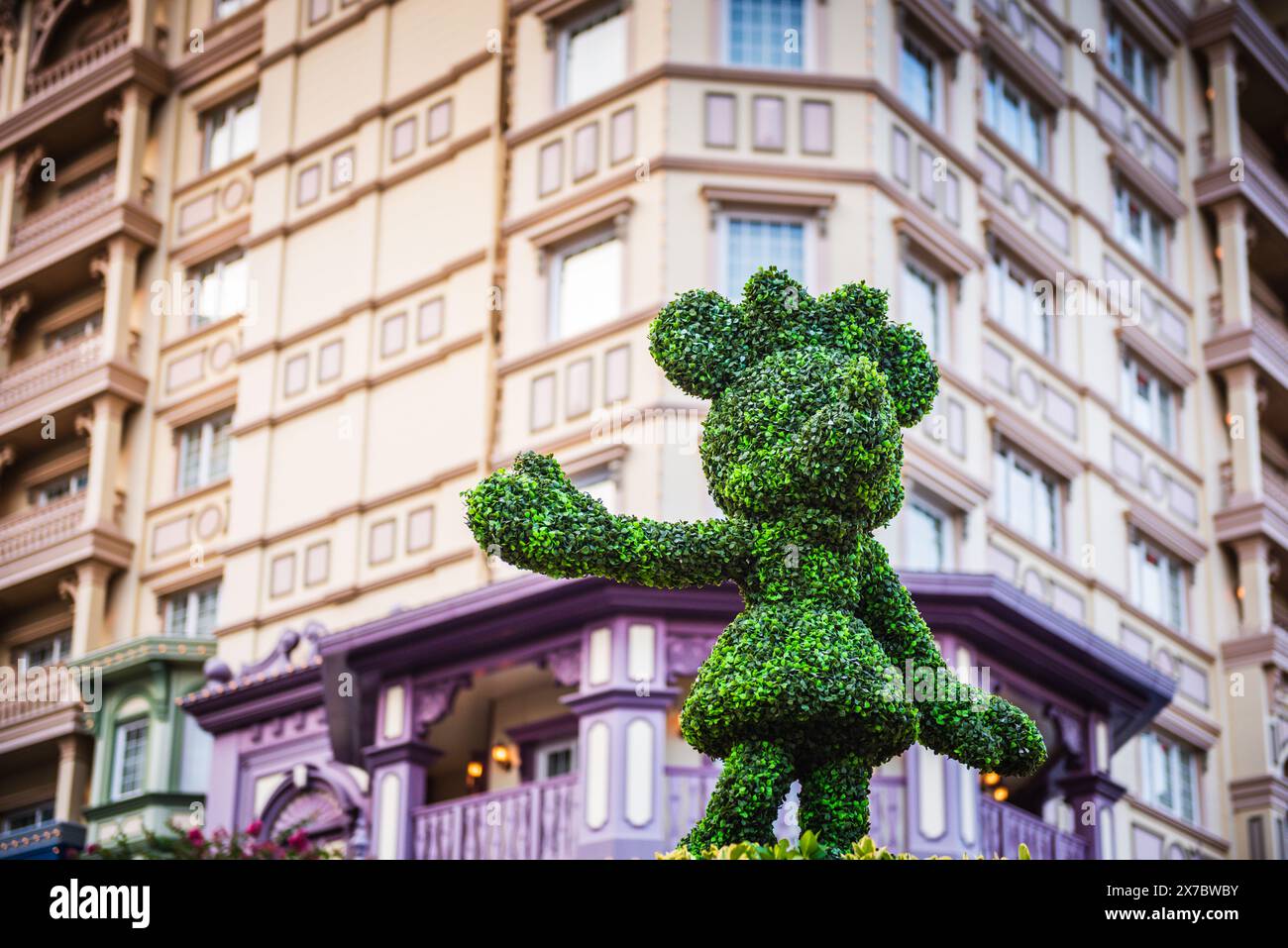 Green topiary plant pruned to resemble Minnie Mouse in frront of Disney ...