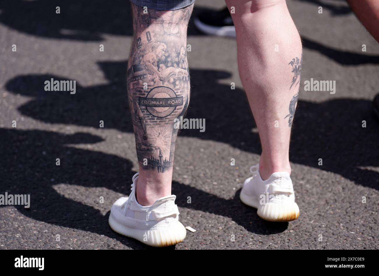 An Arsenal fan sports a tattoo on his leg ahead of the Premier League ...