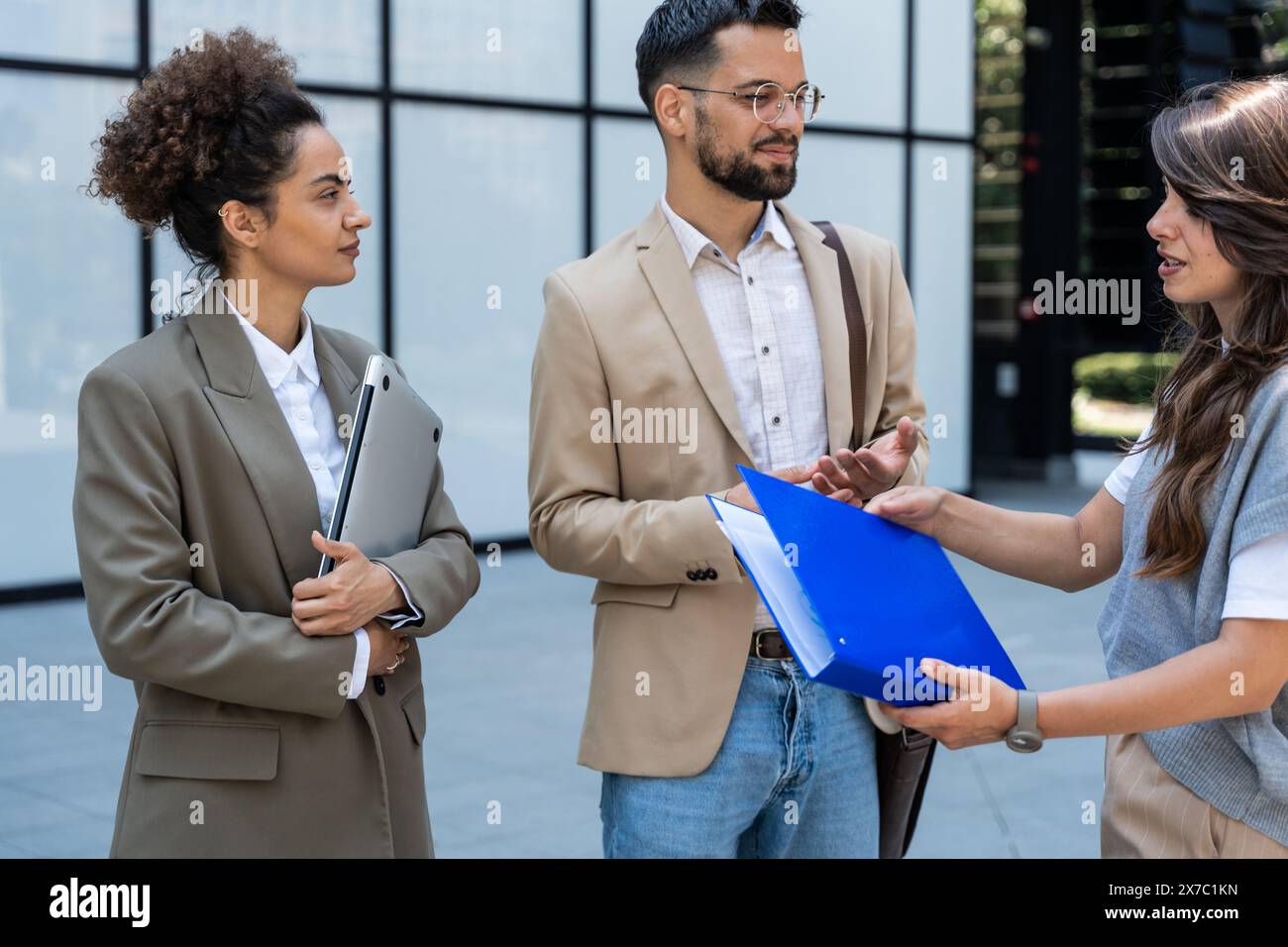 Successful business people working, talking together in urban ...