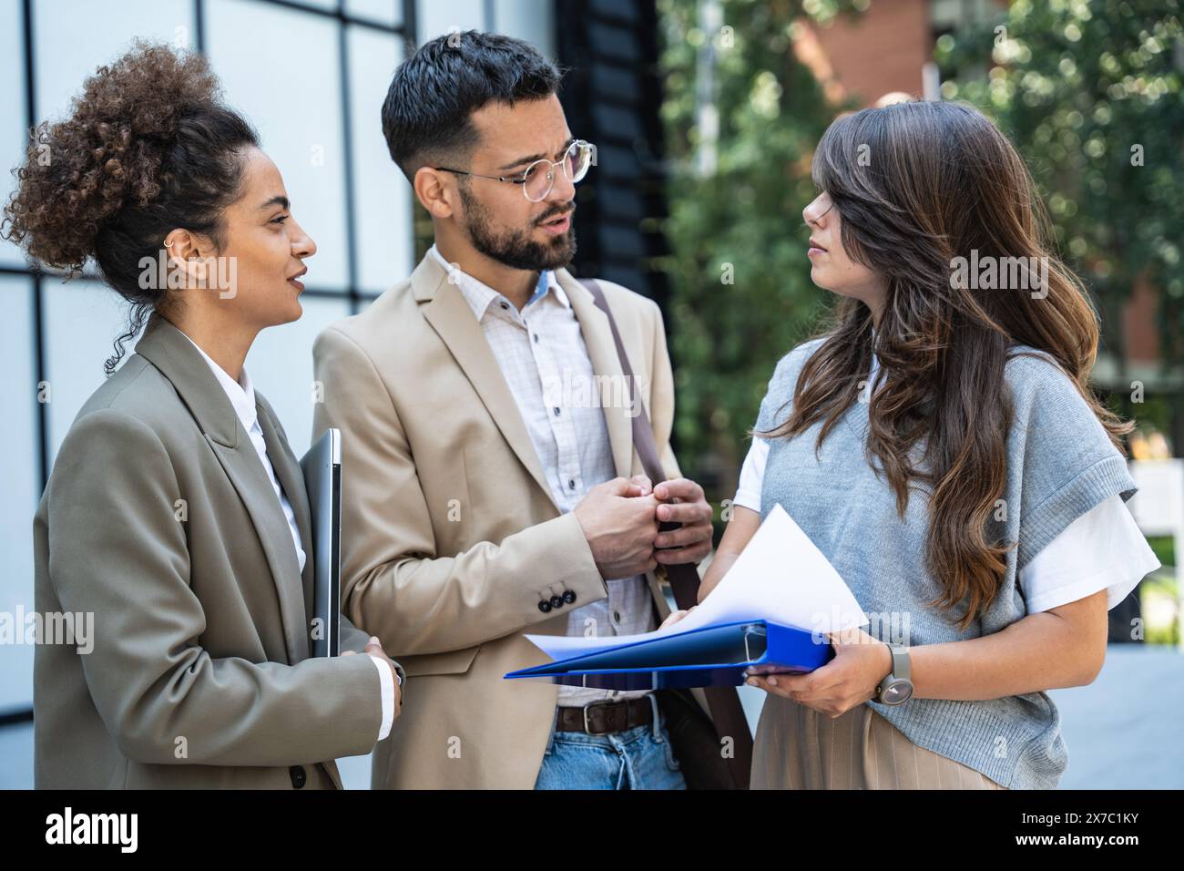 Successful business people working, talking together in urban ...