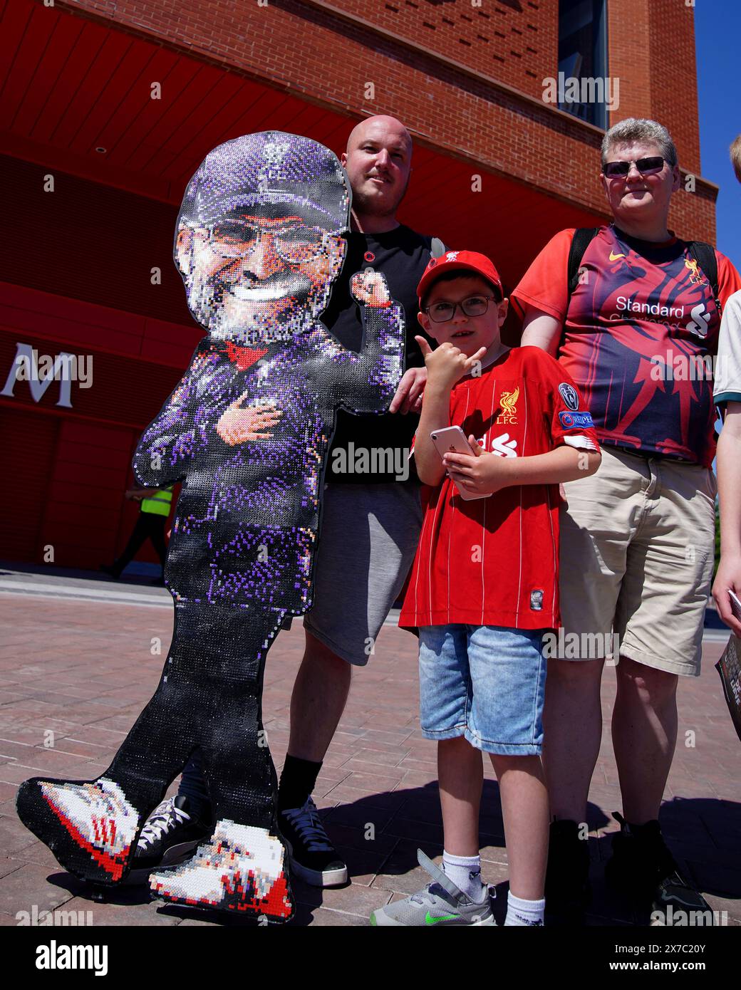 Liverpool fans pose for a photo with a design of Jurgen Klopp made out ...