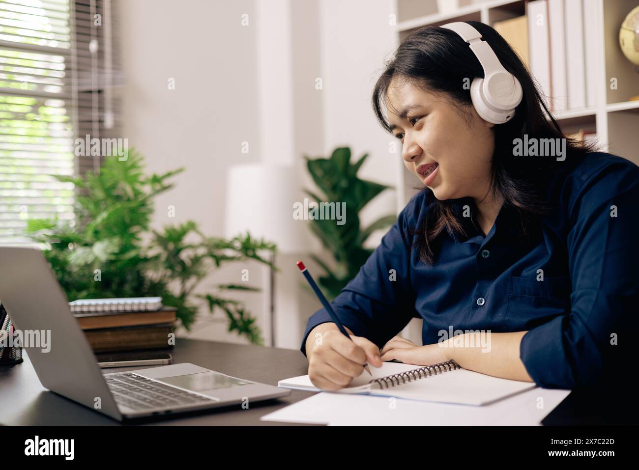 Happy student, studying for MBA exam, takes advantage of distance ...