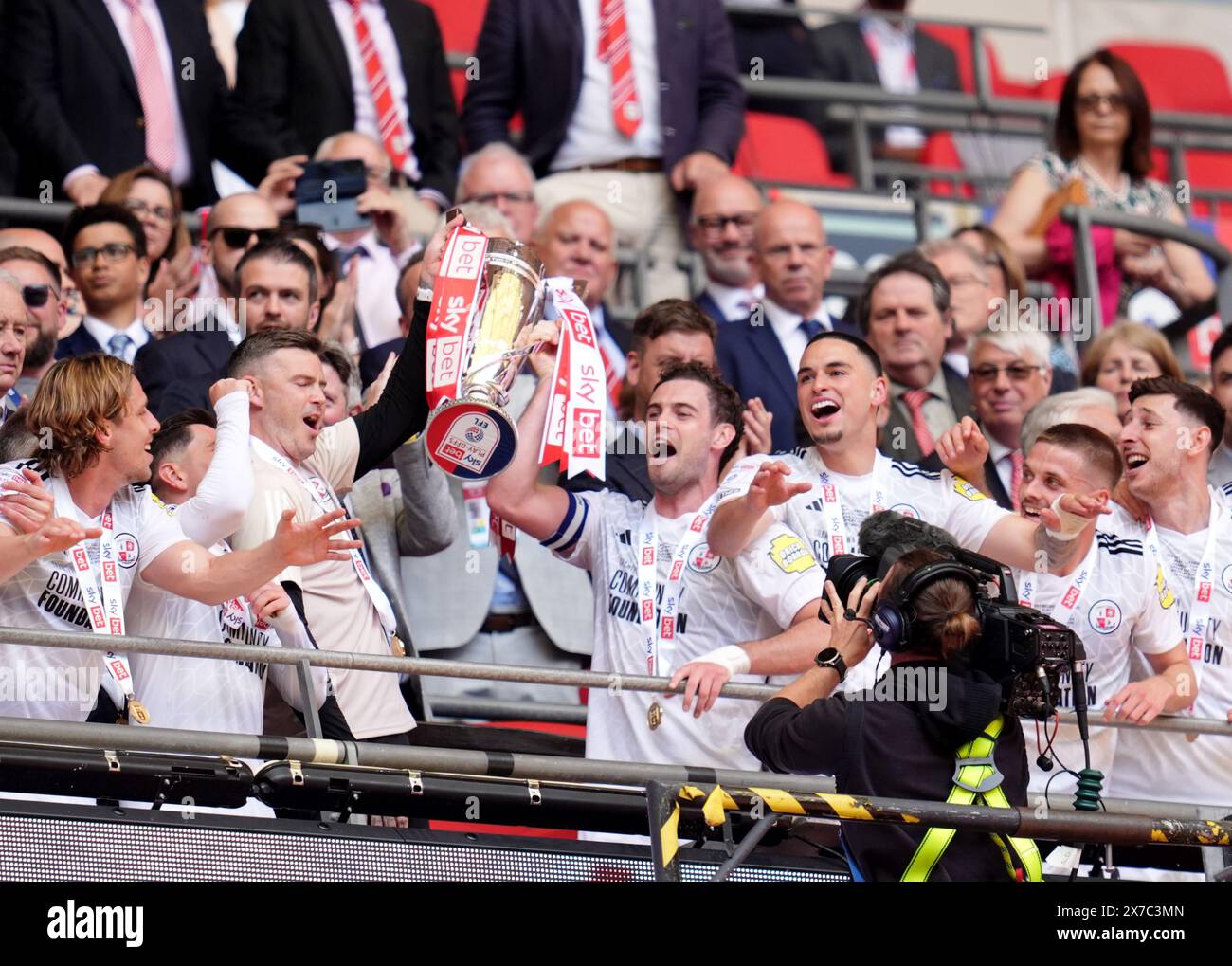 Crawley Town's Dion Conroy lifts the trophy after the Sky Bet League ...
