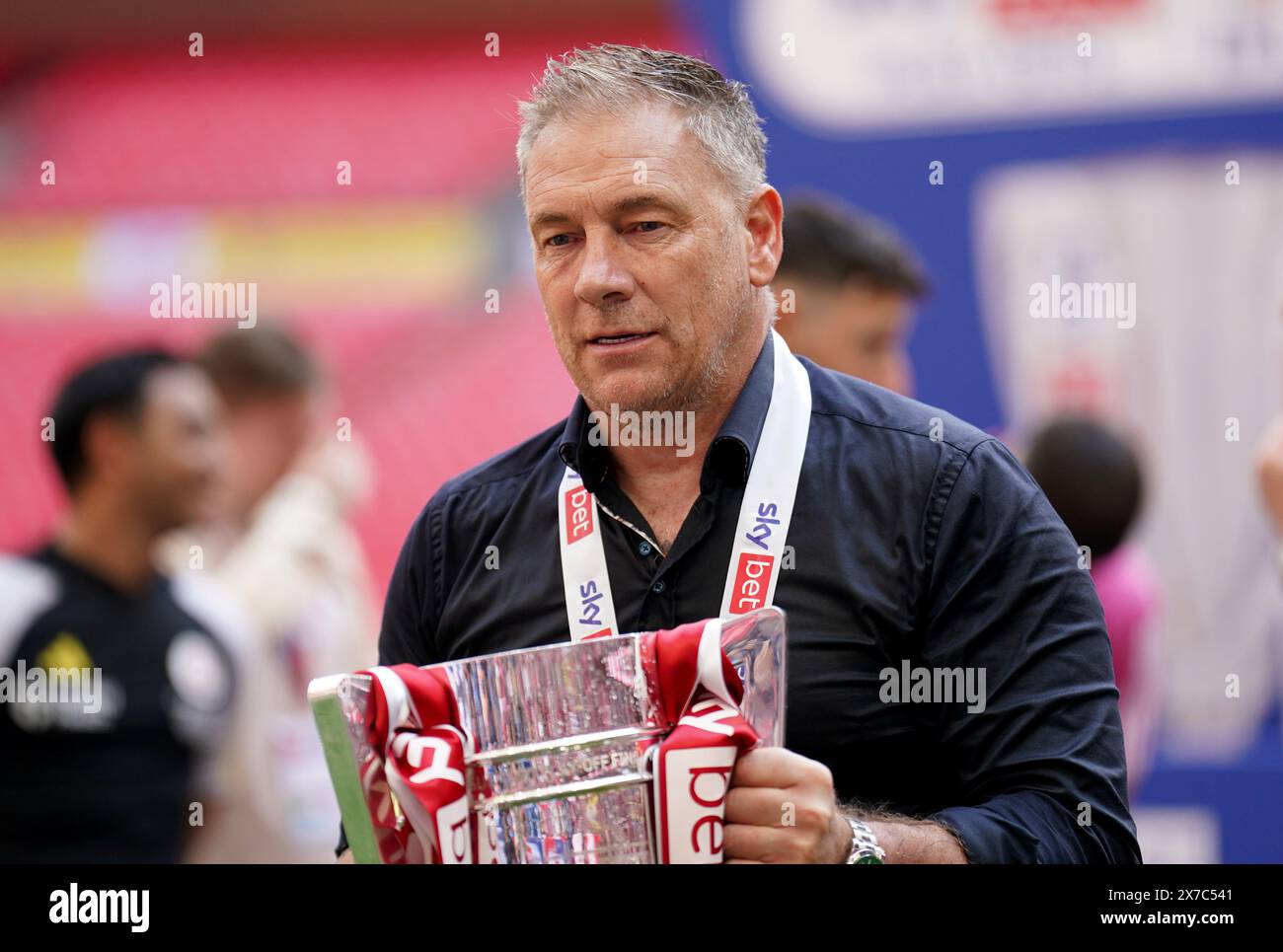 Crawley Town manager Scott Lindsey celebrates on the pitch with the ...