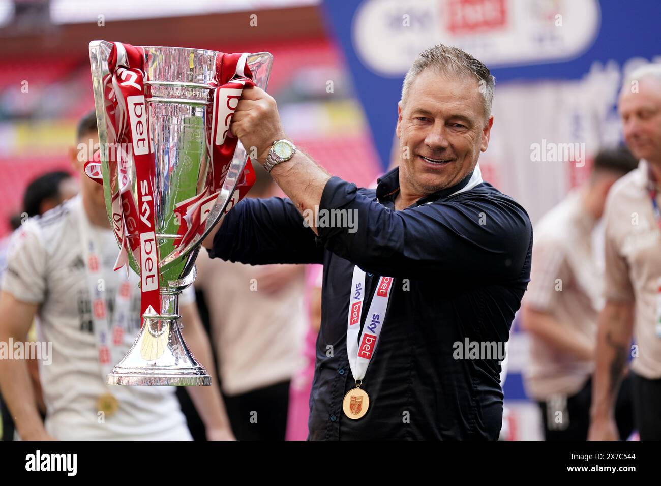 Crawley Town manager Scott Lindsey celebrates on the pitch with the ...