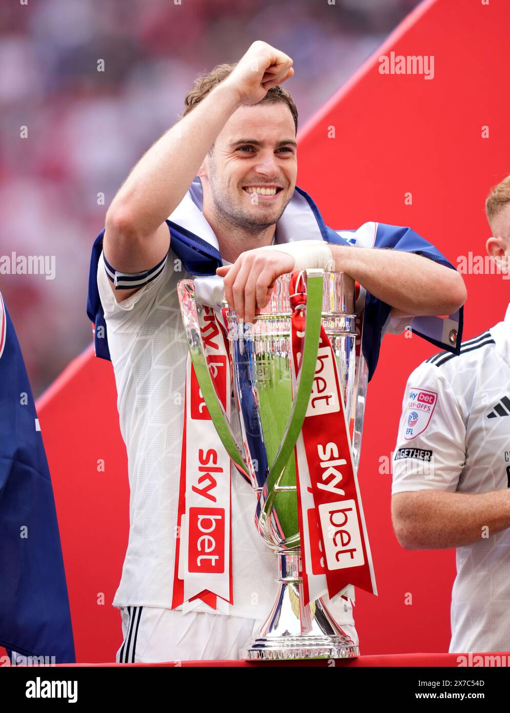 Crawley Town's Dion Conroy celebrates on the pitch with the trophy ...