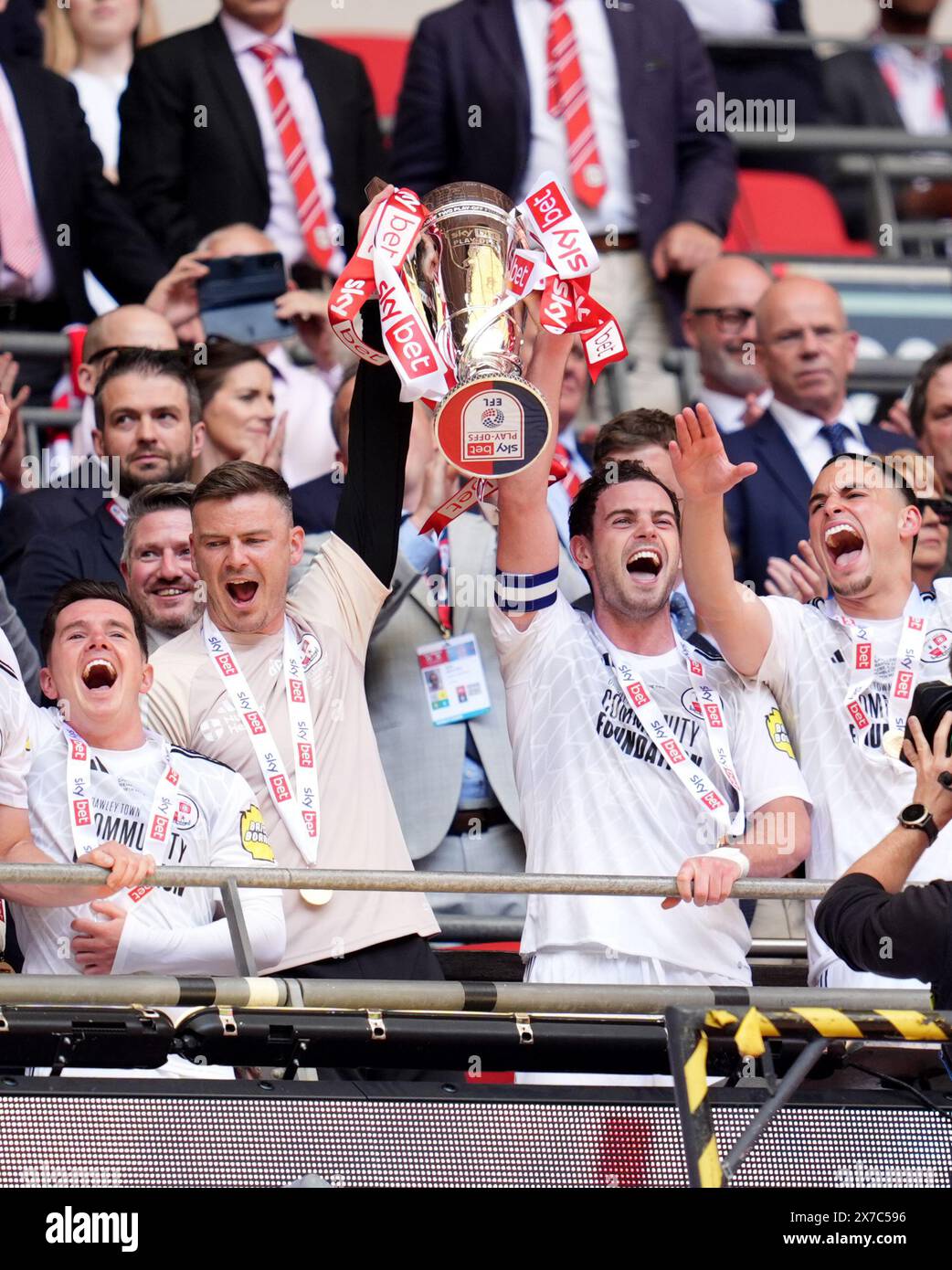 Crawley Town's Dion Conroy lifts the trophy after the Sky Bet League ...