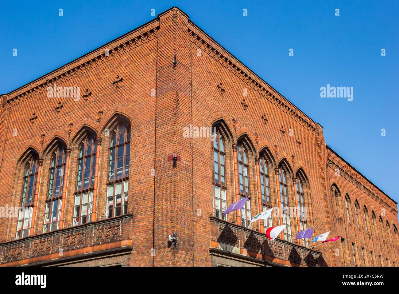 Flags on the facade of the Copernicus school in Torun, Poland Stock Photo - Alamy