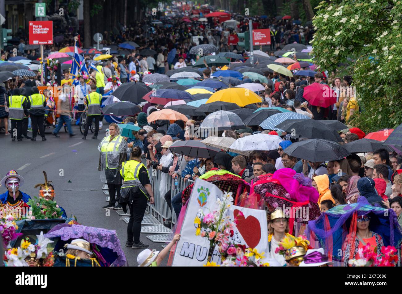 Berlin, Germany. 19th May, 2024. Spectators with umbrellas watch the ...