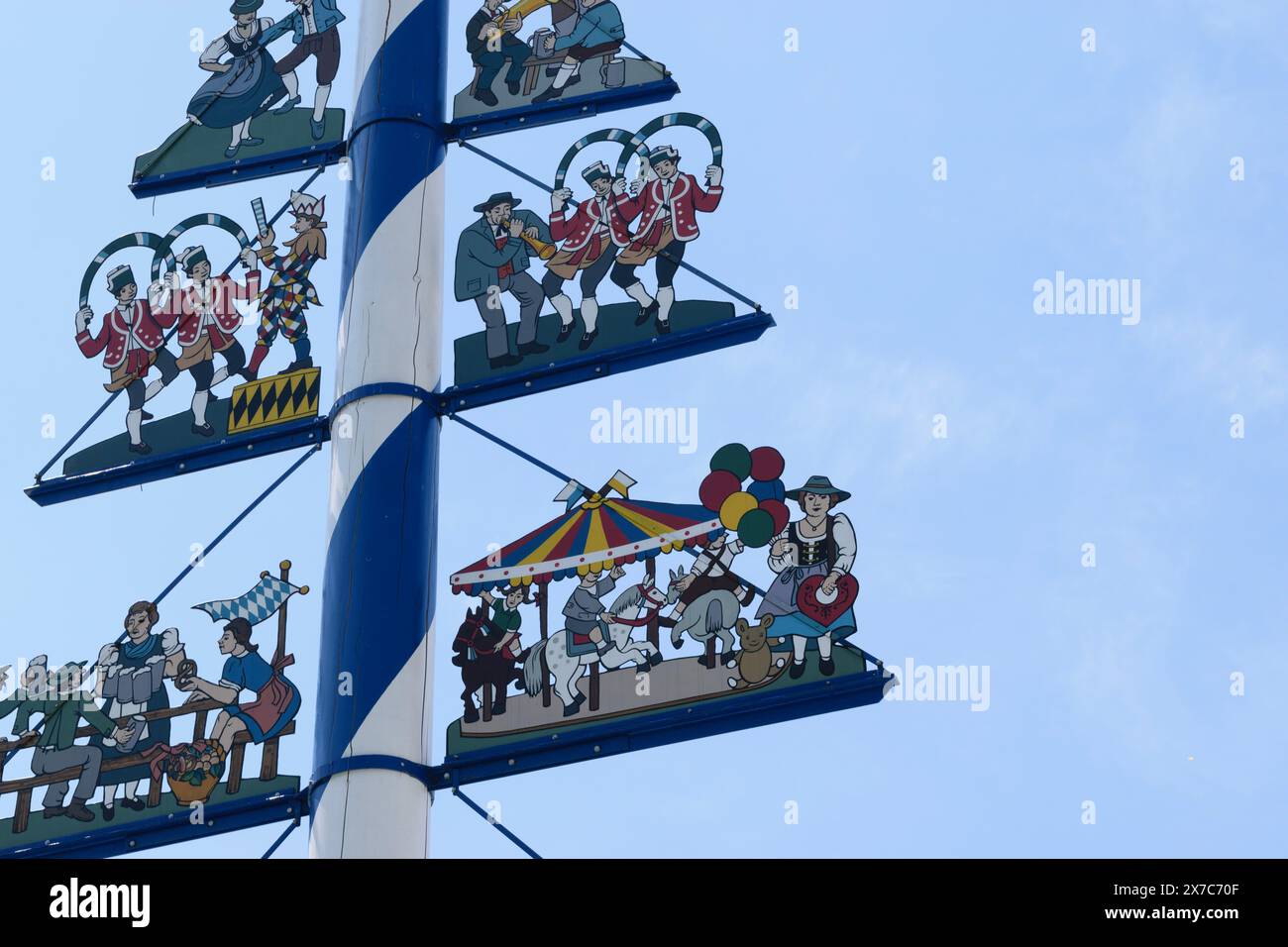 Traditional Bavarian maypole with colorful figures depicting local ...