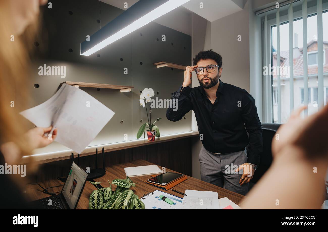 Tense moment in the office: business man looking stressed during a ...