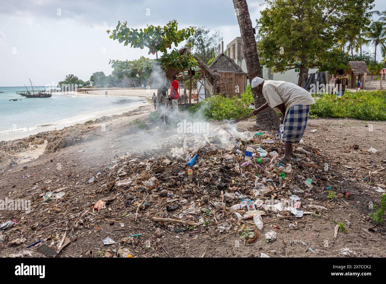 Tanzania, Zanzibar, Ras Nungwi, Burning garbage on the beach Stock ...