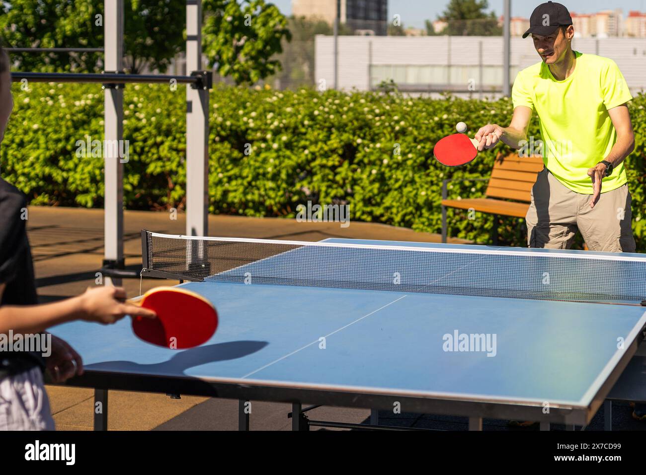 Family playing table tennis outside house Stock Photo - Alamy