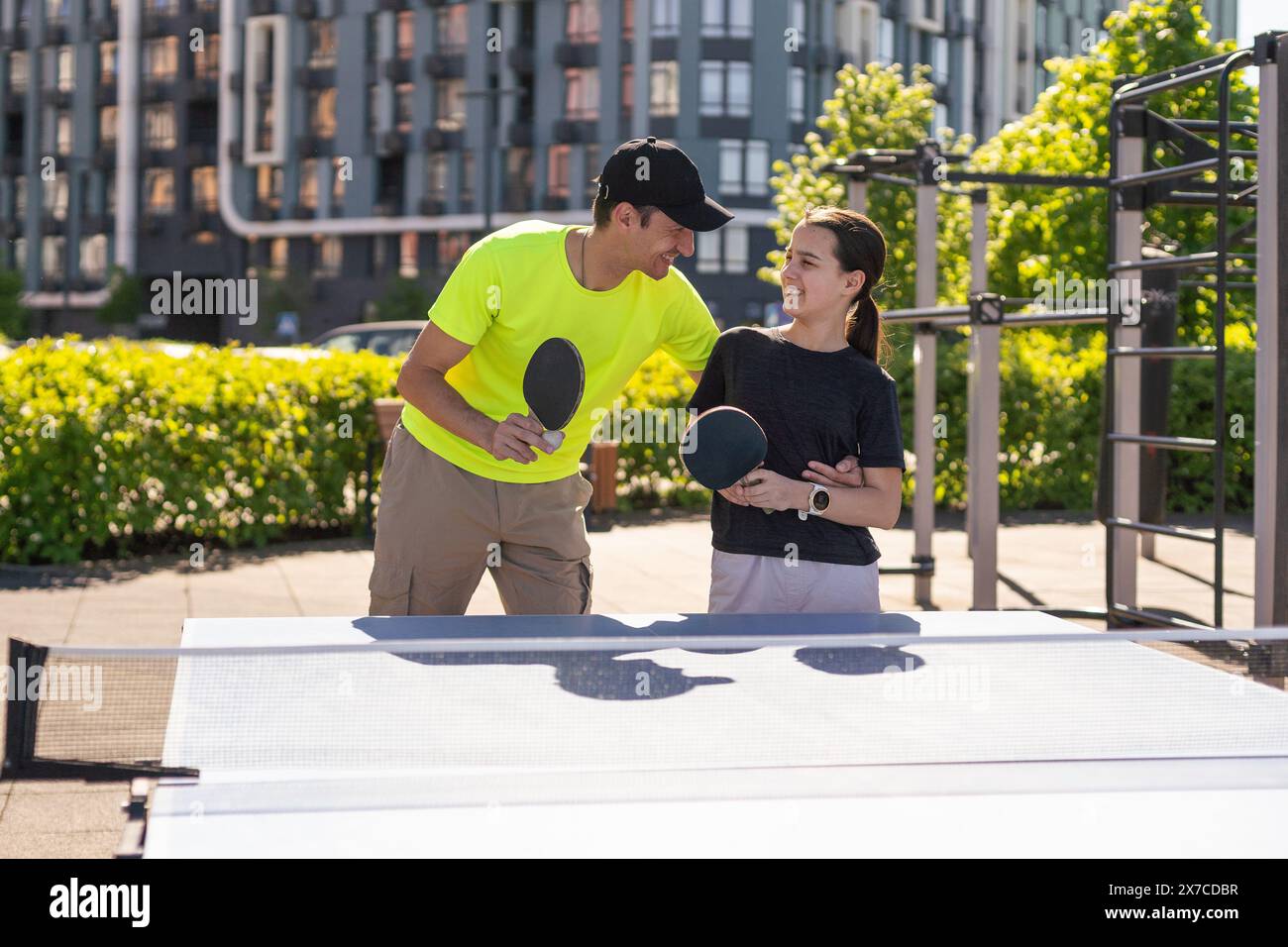 Kid playing table tennis outdoor with family Stock Photo - Alamy