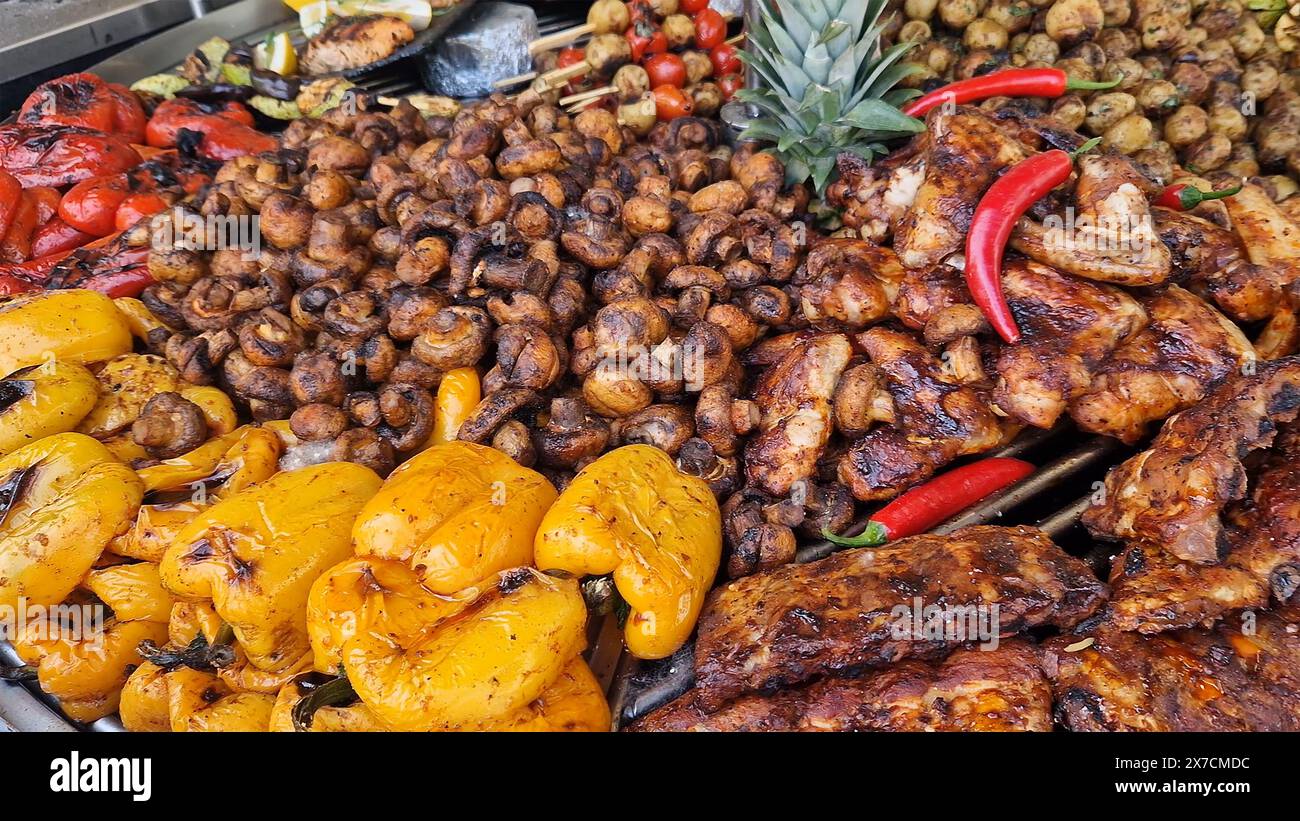 Large round rotating grill with assorted meats and vegetables. Rotary ...