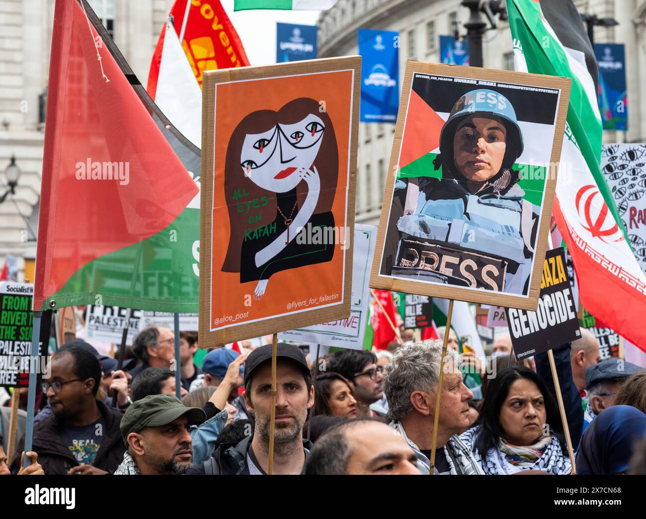 London, UK. 18 May 2024: Protesters hold placards at the Nakba 76 March ...