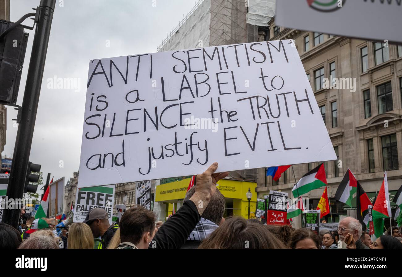 London, UK. 18 May 2024: A man holds a placard claiming Antisemitism is ...