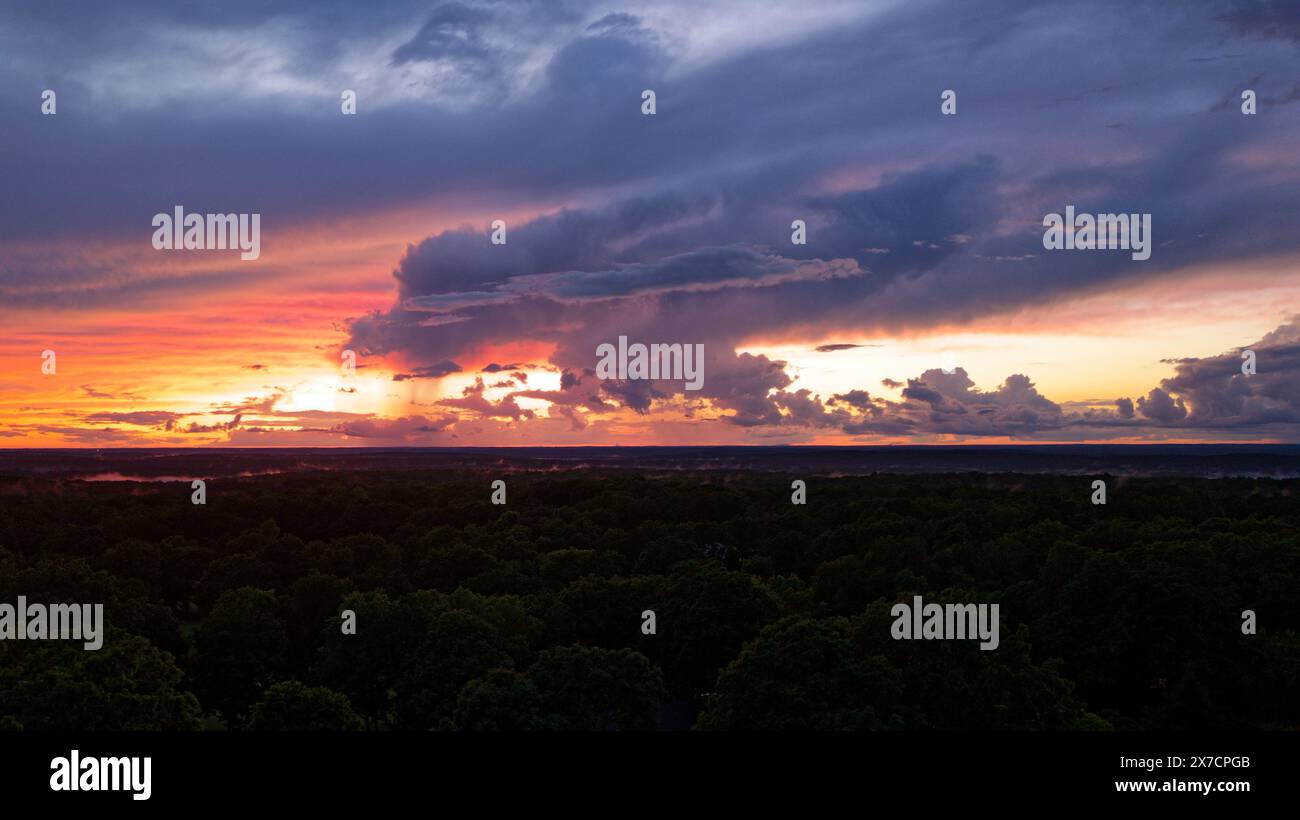 Dramatic sky after a thunderstorm with the sun setting on the horizon ...