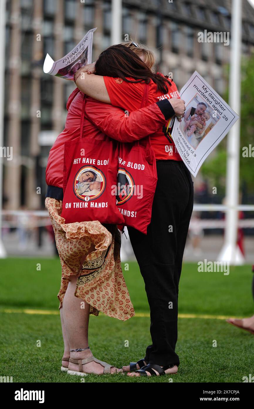 Infected blood campaigners hugging at a meeting in Parliament Square in ...