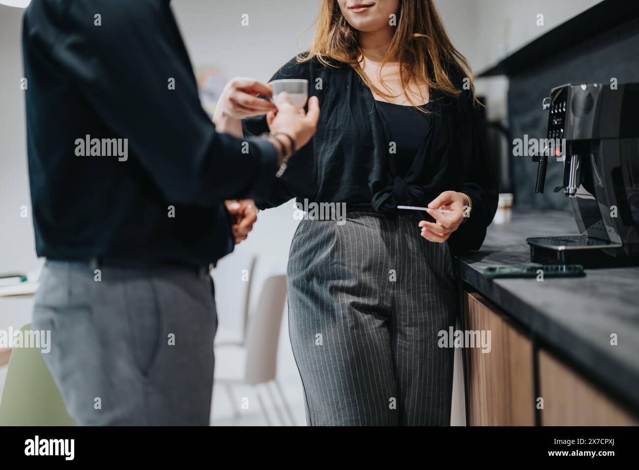 Colleagues enjoying a casual conversation while taking a coffee break ...