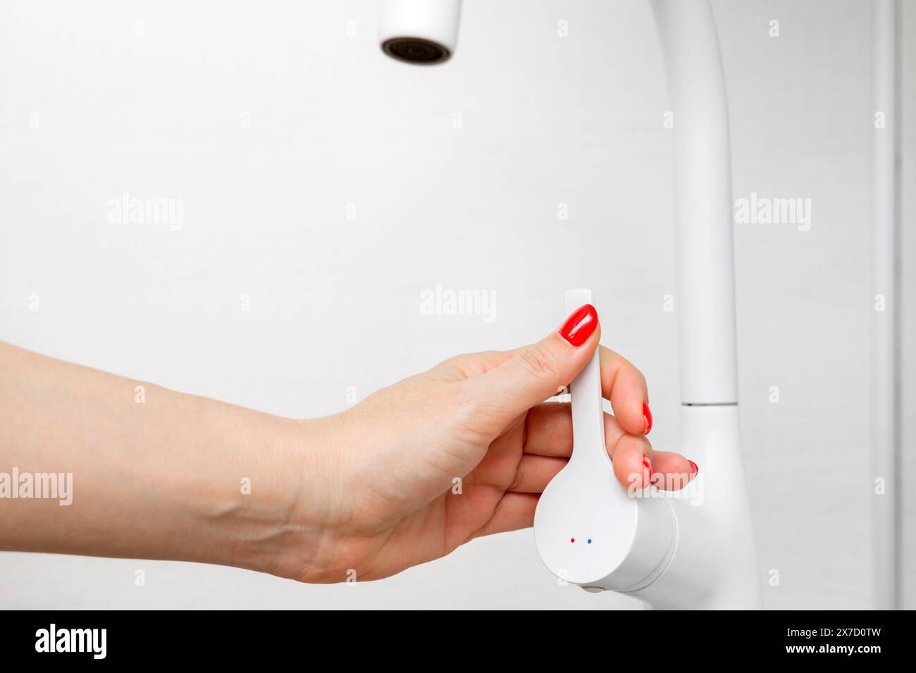 female hand turns the selector on the kitchen faucet Stock Photo - Alamy
