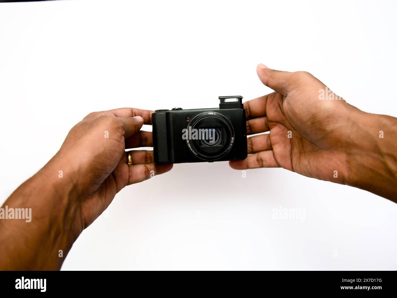 A close-up image of a photographer's hands securely holding a ...