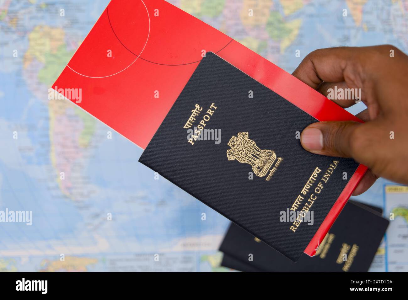 A close-up photo of a South Asian man holding an Indian passport in ...