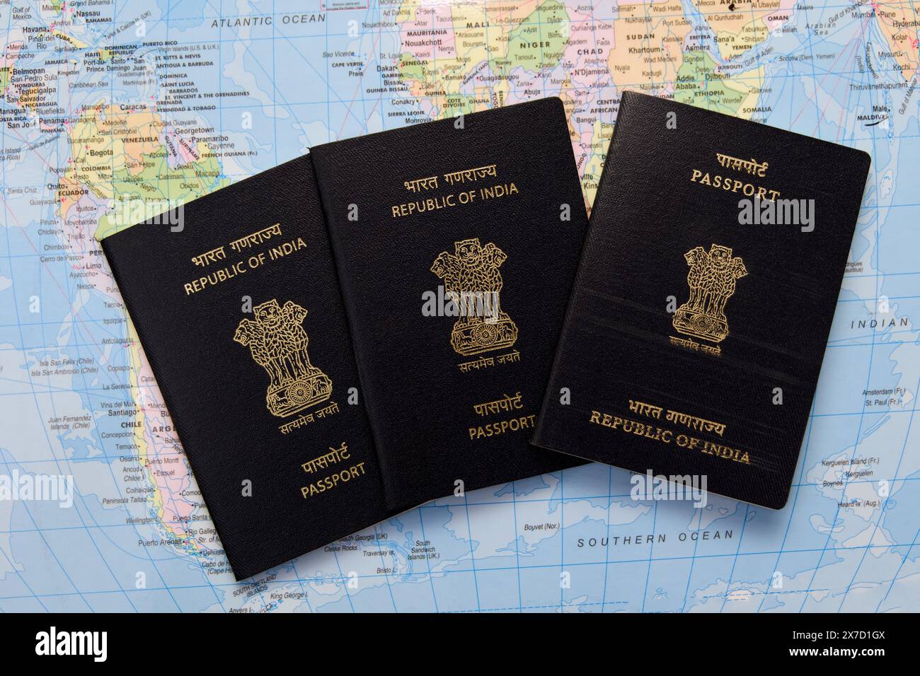 This image is about Three indian passports on a world map background ...