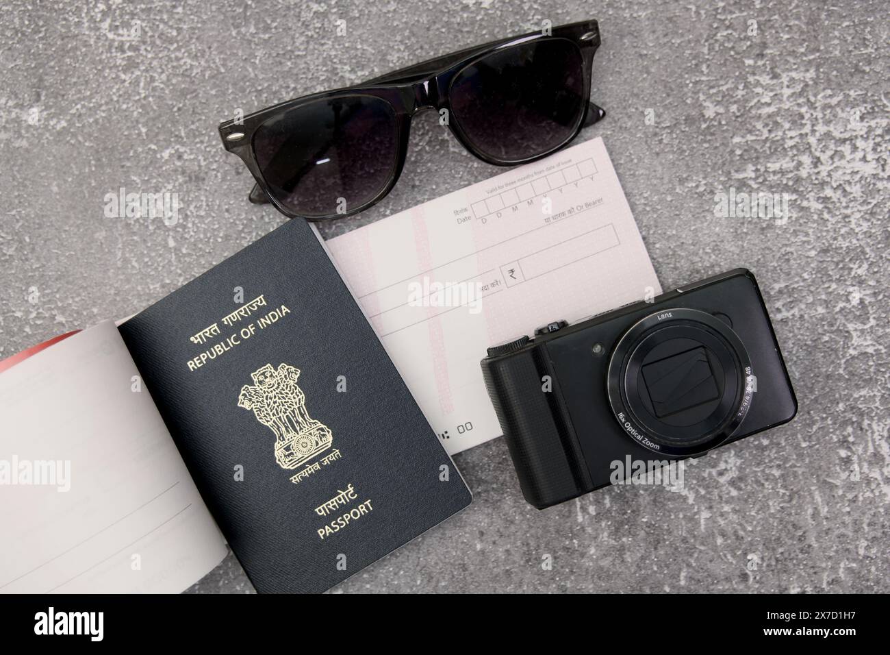 This image showcases travel must-haves: a Indian passport, camera ...