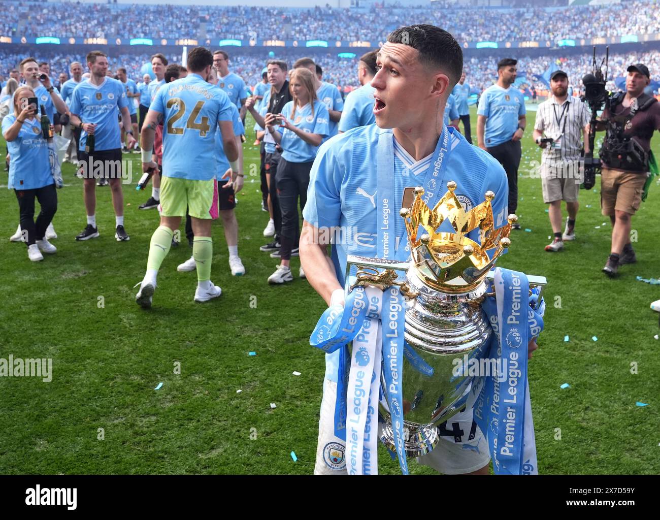 Manchester City's Phil Foden celebrates with the Premier League trophy ...