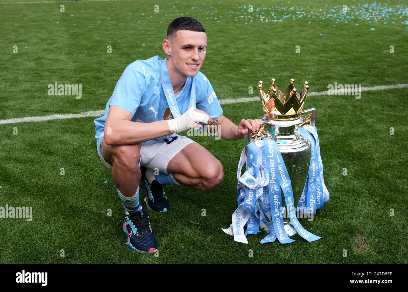 Manchester City's Phil Foden celebrates with the Premier League trophy ...