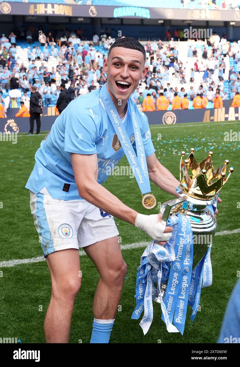 Manchester City's Phil Foden celebrates with the Premier League trophy ...