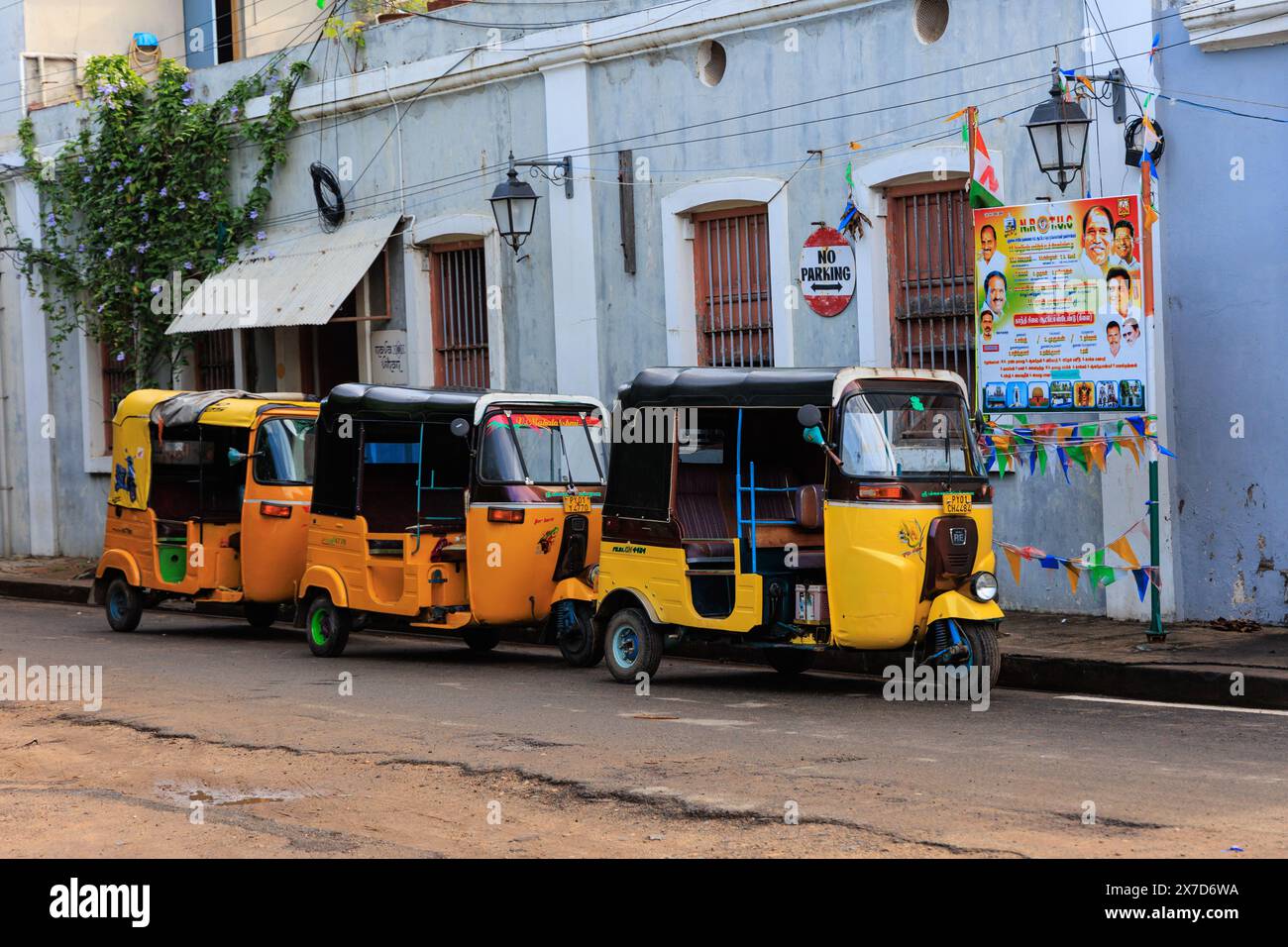 Yellow auto-rickshaws parked roadside in Pondicherry Stock Photo - Alamy