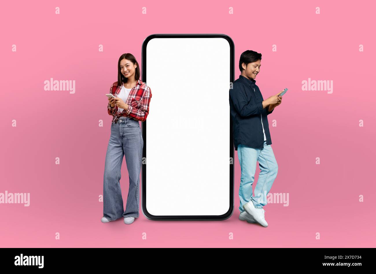 Young Chinese couple, both grinning, positioned next to life-sized ...