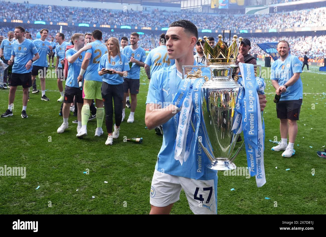 Manchester City's Phil Foden celebrates with the Premier League trophy ...